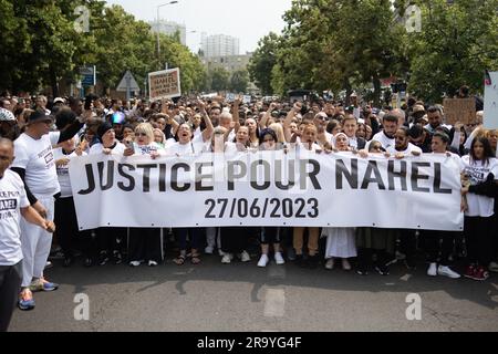 People hold a sign justice for Nahel during a commemoration march ...