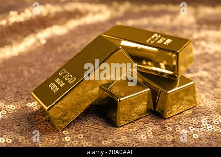Shiny gold bars on sequin fabric, above view Stock Photo - Alamy