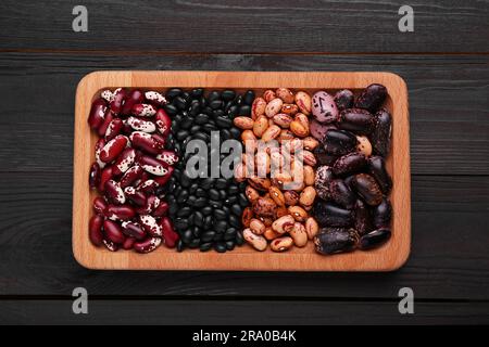 Plate with different kinds of dry kidney beans on light grey wooden ...