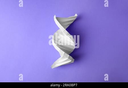 Paper model of DNA molecular chain on black background, top view. Space ...