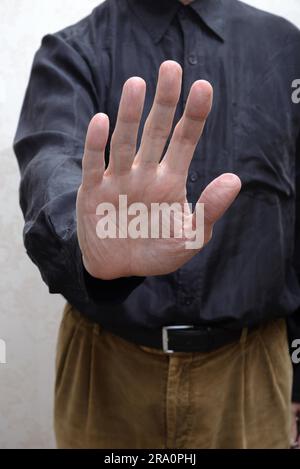 A man saying stop or no with the open hand gesture. Refusing to take ...