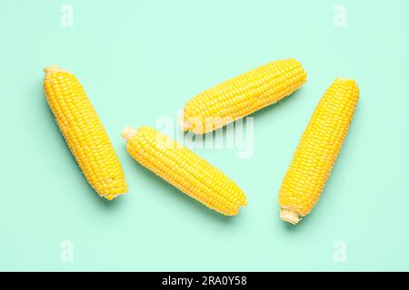 Fresh corn cobs on turquoise background Stock Photo - Alamy