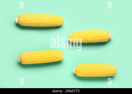 Fresh corn cobs on turquoise background Stock Photo - Alamy