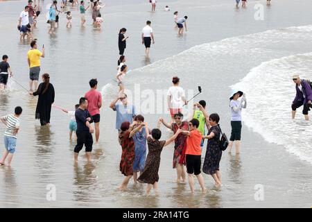 FUZHOU, CHINA - JUNE 23, 2023 - Tourists cool off at the beach during ...