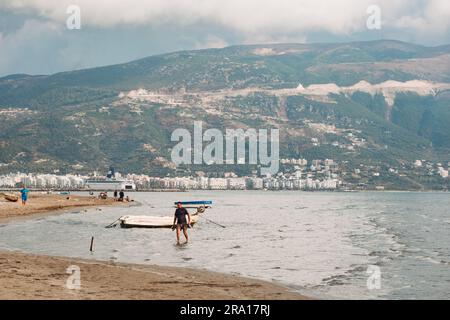 Small boats anchored at Plazhi i Vjeter (Old Beach) in the coastal city ...