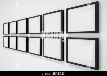 In the white-walled showroom, frames with empty interiors are exhibited ...