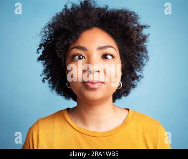 Funny face, goofy and woman with emoji, silly and humor against a brown ...