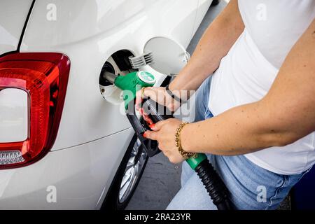 HELMOND - A woman fills up her car at a Tango gas station in Helmond ...