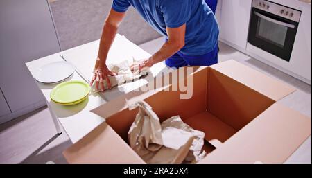 Packing Dishes In Home Apartment Room. Moving Service Stock Photo - Alamy