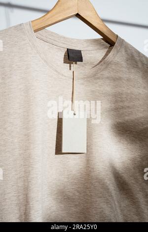 Blank clothes tag on beige wool background closeup Stock Photo - Alamy
