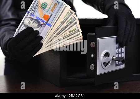 Thief steals money from a steel safe Stock Photo - Alamy