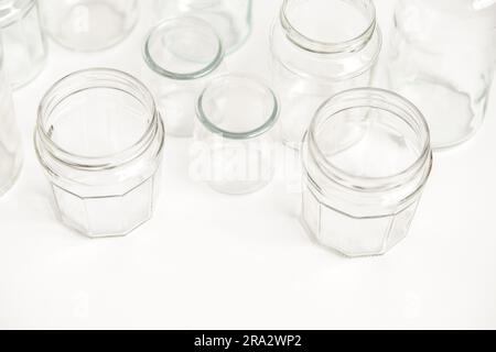 Assorted set of glass containers without lids on white background ...