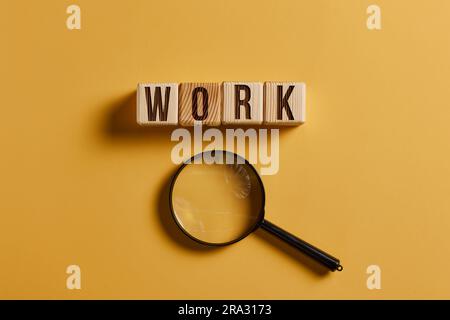 The word work is inscribed in wooden cubes. blue background Stock Photo ...
