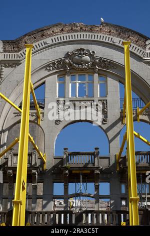 Large yellow scaffolding during total renovation of an old building ...