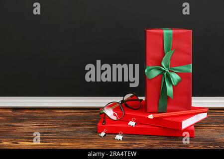 Gift box with eyeglasses, books and different stationery on table in ...