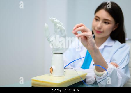 Technician testing robotic bionic arm at prosthetic manufacturing Stock ...