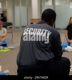 CPR training class by security guard in office Stock Photo - Alamy