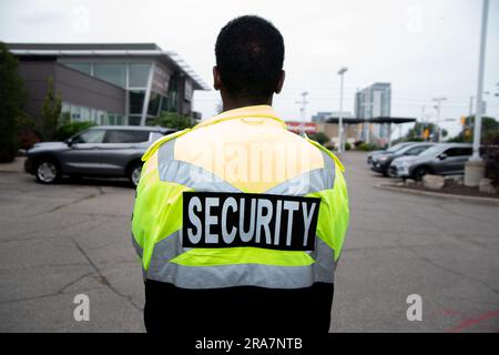 Security guard patrolling office parking space Stock Photo - Alamy