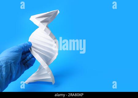 Paper model of DNA molecular chain on black background, top view. Space ...