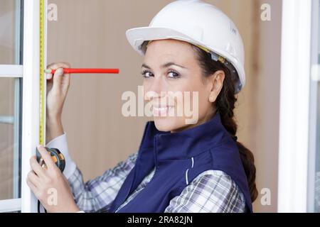 happy woman measuring window frame Stock Photo - Alamy
