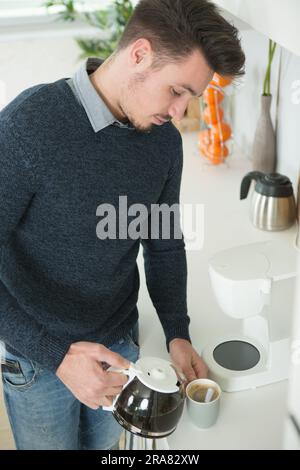 close up. a man pouring himself a Cup of morning coffee Stock Photo - Alamy
