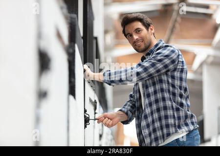 Man client using automated self service post terminal machine or locker ...