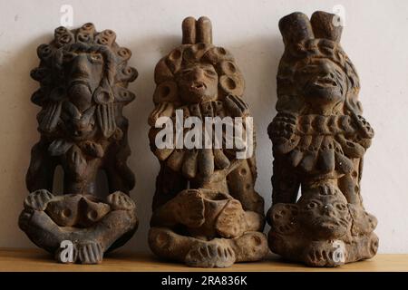 Mayan god clay statues on wooden and white background with copy text ...