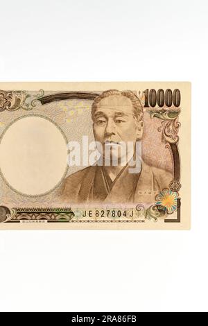 Front view of 10000 yen note in close-up isolated on white background ...