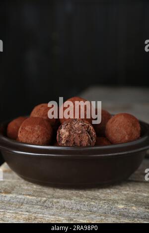 Round candies coated with cocoa powder with marzipan filling isolated ...