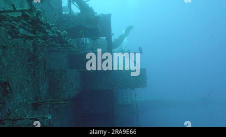 Scuba diver swim along deck of ferry Salem Express shipwreck, Back view ...