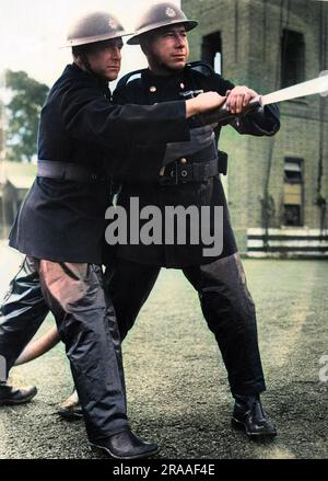 Firemen at hose drill during World War II Stock Photo - Alamy