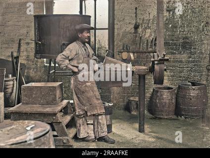 A workman in a factory, having a break from his work. The factory ...