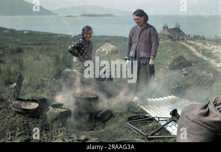 Two women with a smoking brazier in a rural landscape on the Isle of ...
