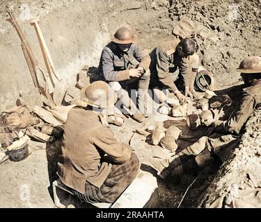 Gordon Highlanders cutting up rations in a reserve trench before moving ...