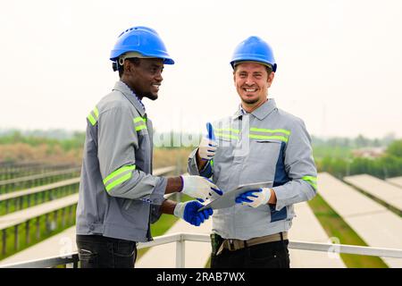 Happy maintenance engineers checking and maintaining solar panels Stock ...