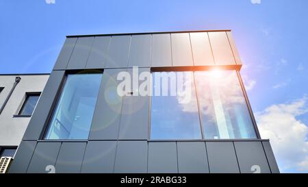 Graphite facade and large windows on a fragment of an office building ...