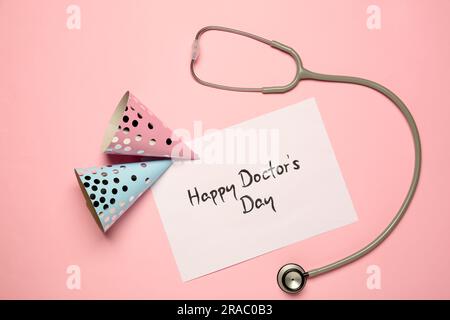 Card with phrase Happy Doctor's Day, stethoscope and gift boxes on ...