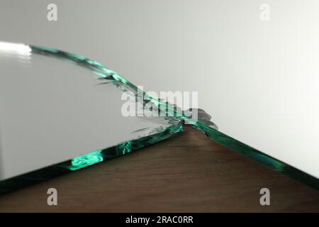 Shard of broken mirror on wooden backing board, closeup Stock Photo - Alamy
