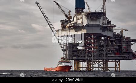 Supply vessel doing cargo operations with jack up drilling rig ...