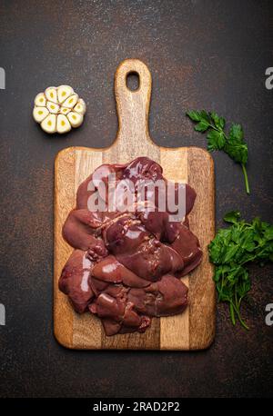 Raw chicken liver, fresh fowl giblets on wooden board. Isolated, white ...
