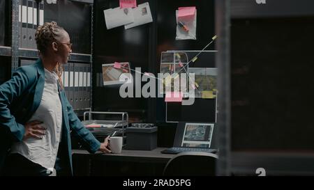 Police investigator examining clues from crime scene, looking at ...