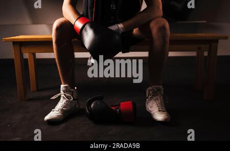 Closeup of boxer legs resting on bench in gym after training. High ...