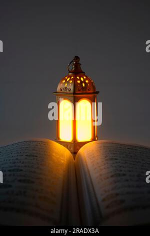 Quran and Arabic lamp with bright light with the sunset scene ...