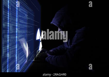 Nuclear deterrence. Warning radiation symbol, source and binary codes on black background Stock ...
