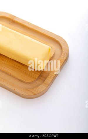 A stick of butter isolated on a white studio background. One kilo of ...