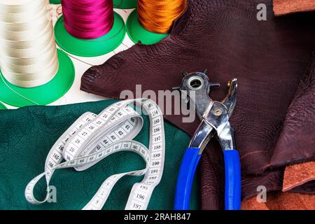 A piece of leather with scissors, needles, chalk Stock Photo - Alamy