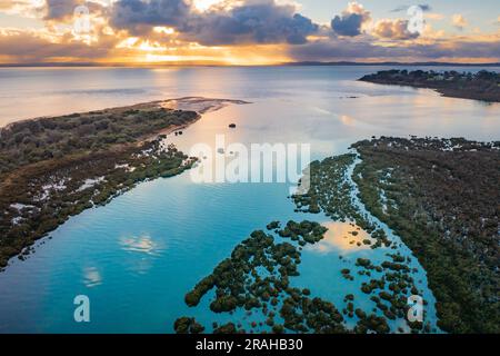 creek leading out to the ocean in the morning light Stock Photo - Alamy