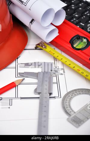 caliper, construction drawings, tape line and helmet. Desk Engineer ...