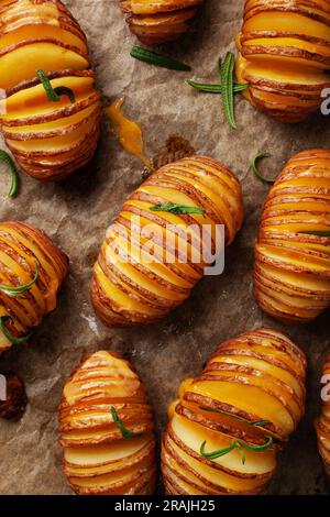 baked hasselback potato with cheddar cheese and rosemary Stock Photo ...