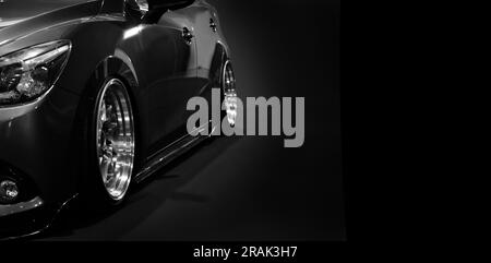 Front headlights of black modify car on black background, copy space ...